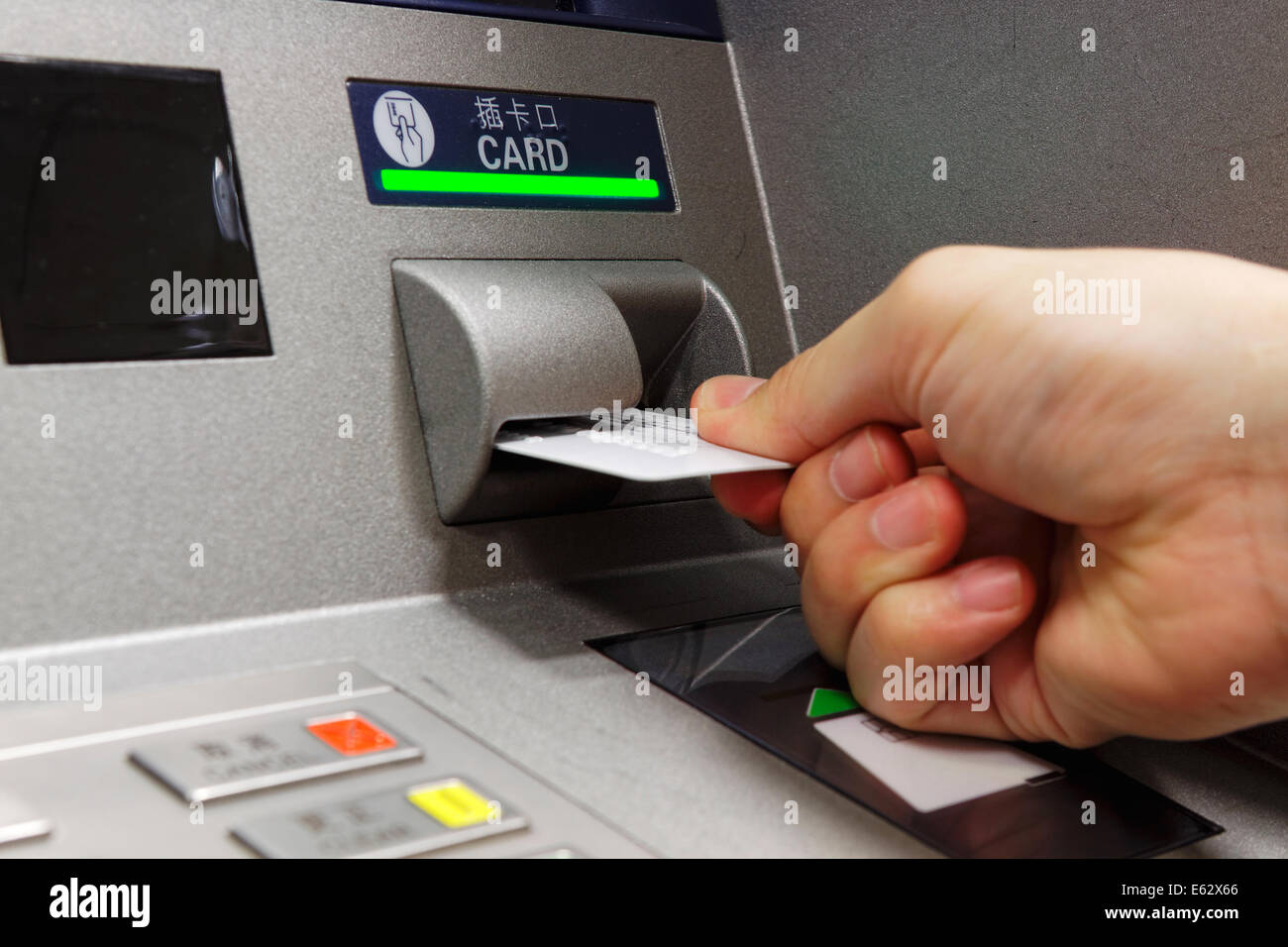 male hand businessman inserts credit card into the ATM and withdraws ...