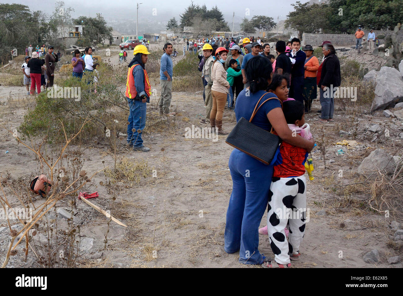 Quito, Ecuador. 12th Aug, 2014. People remain outside their homes after ...
