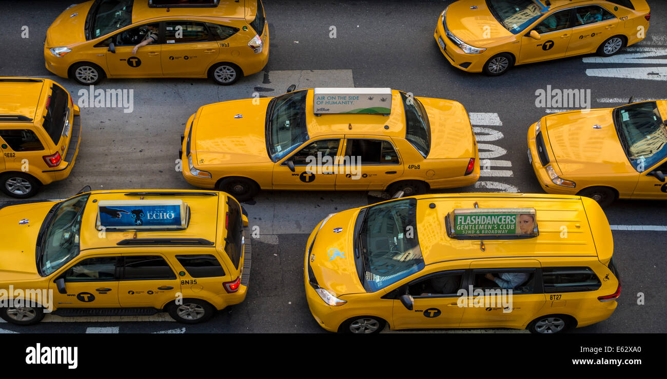 Manhattan, New York city. Yellow Taxis on a street. Advertisement ...