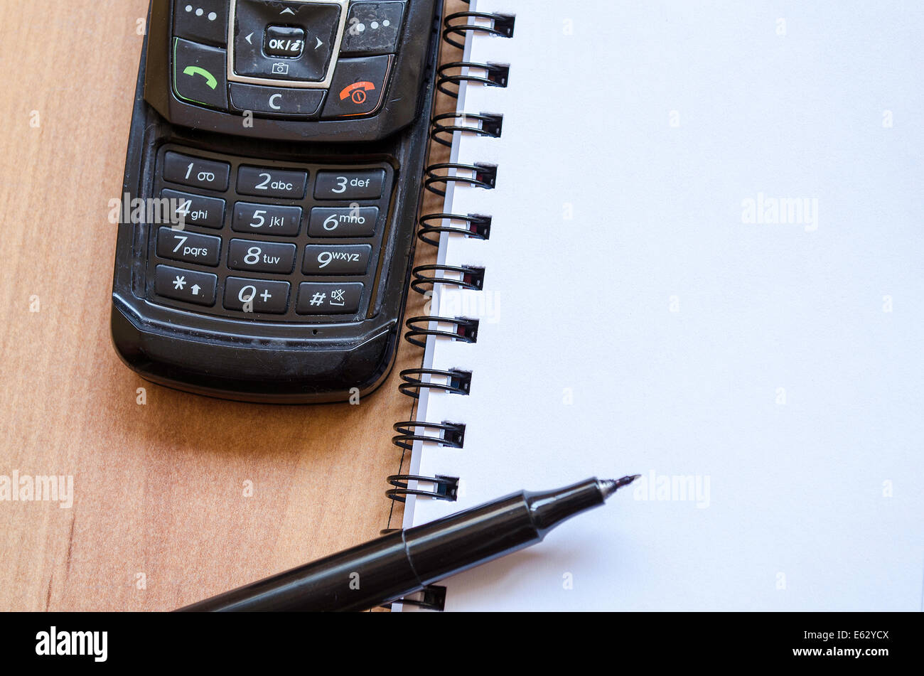 Blank notebook and ink pen on a wooden desk and old phone Stock Photo ...