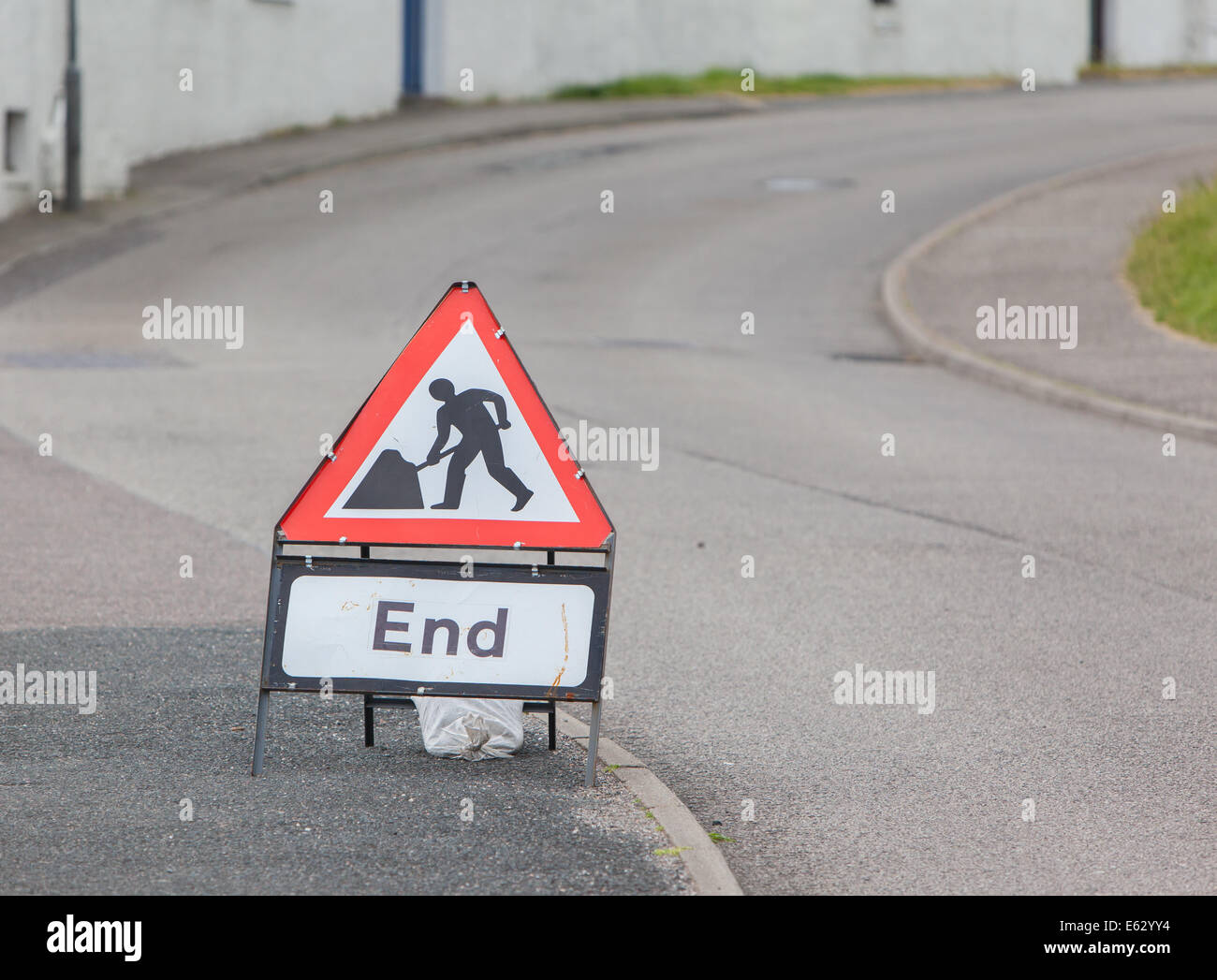 Triangular construction sign standing on footpath, end of construction ...