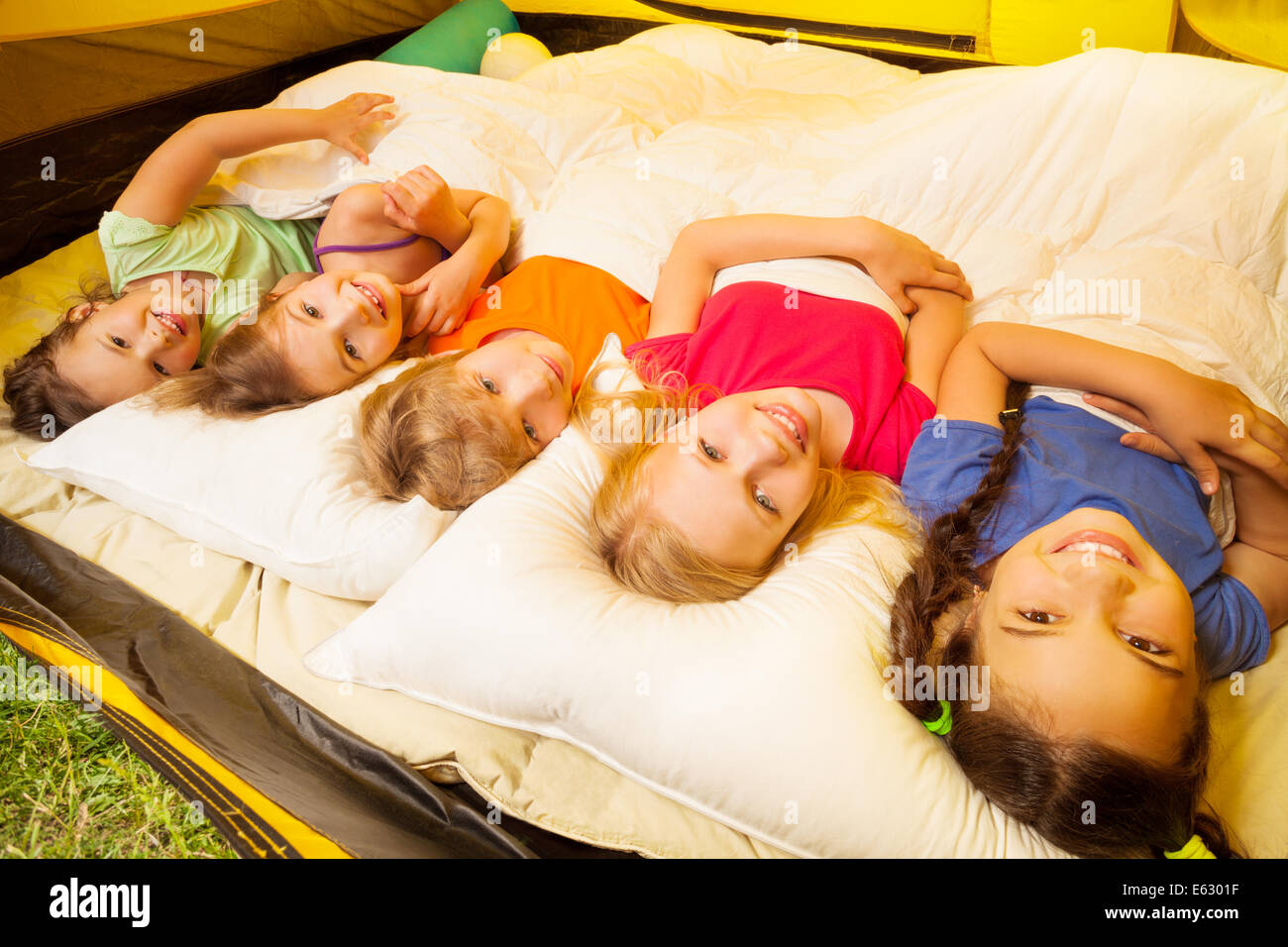 Five pretty kids lay covered with blanket Stock Photo - Alamy