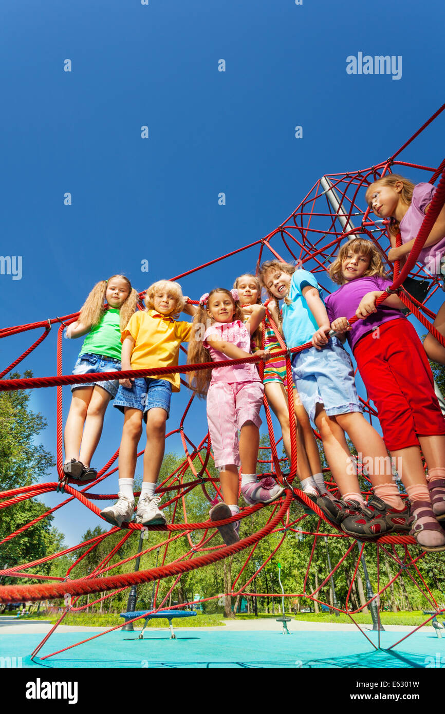 Many kids standing on the ropes of playground net Stock Photo - Alamy