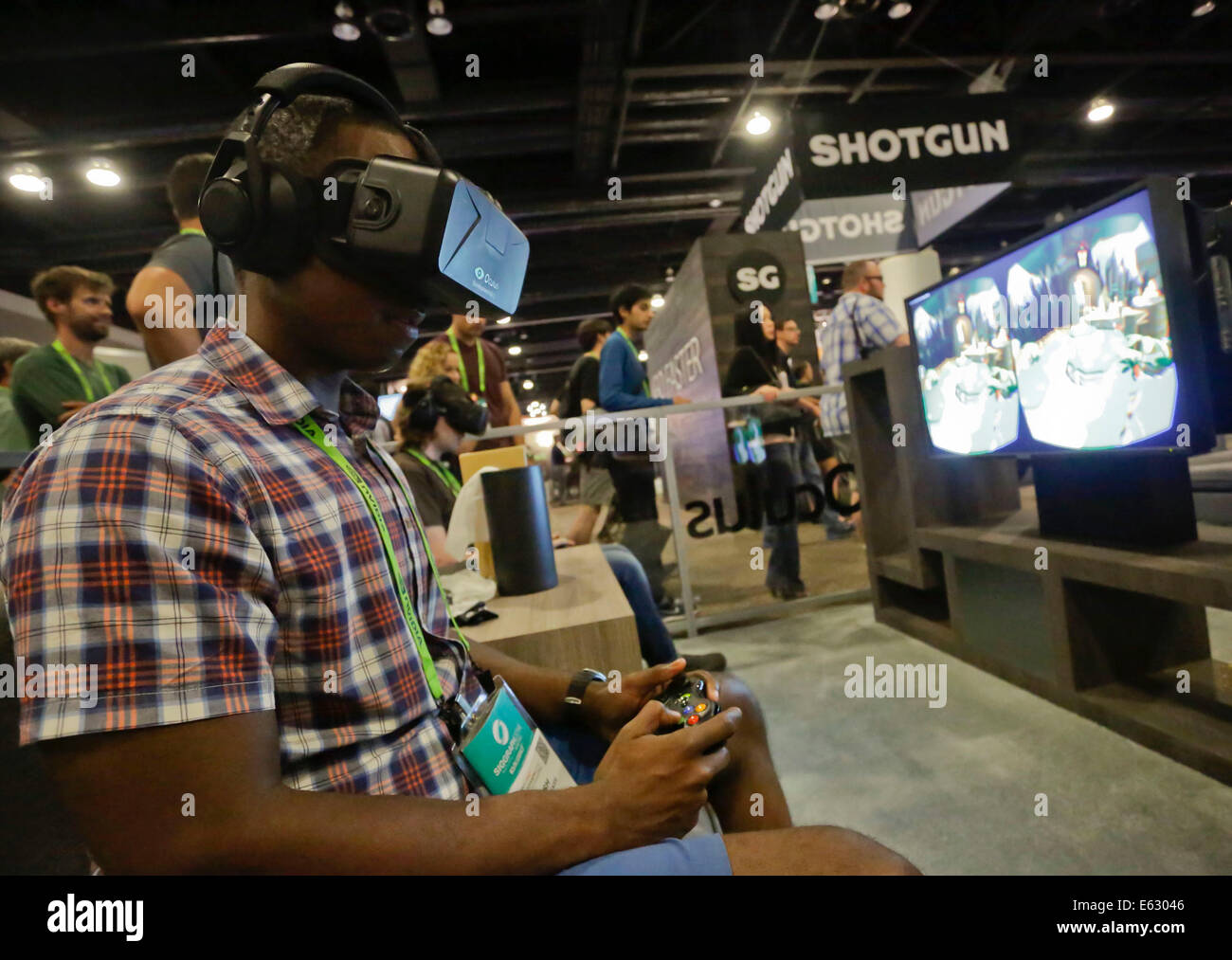 Vancouver, Canada. 12th Aug, 2014. A visitor plays a 3D game with a goggle on at the SIGGRAPH ...