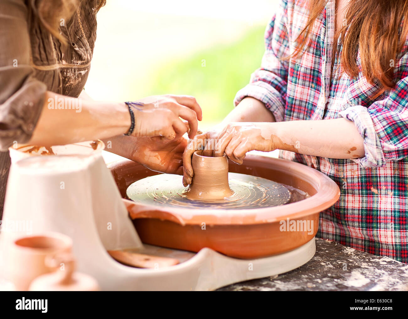 Female Potter creating a bowl on a Potters wheel, the master potter ...