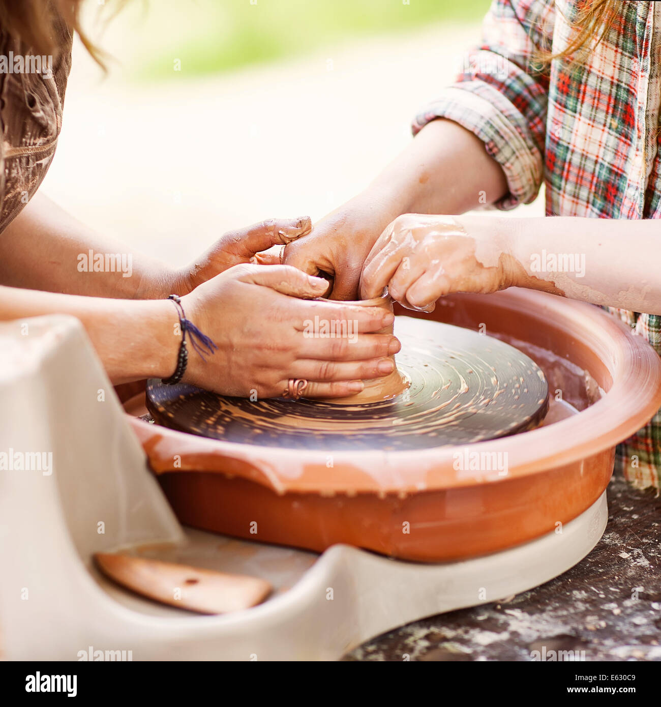 Female Potter creating a bowl on a Potters wheel, the master potter ...