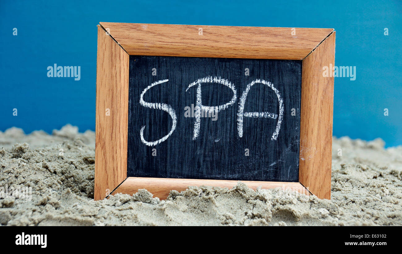 Spa written on a chalkboard at the beach Stock Photo - Alamy