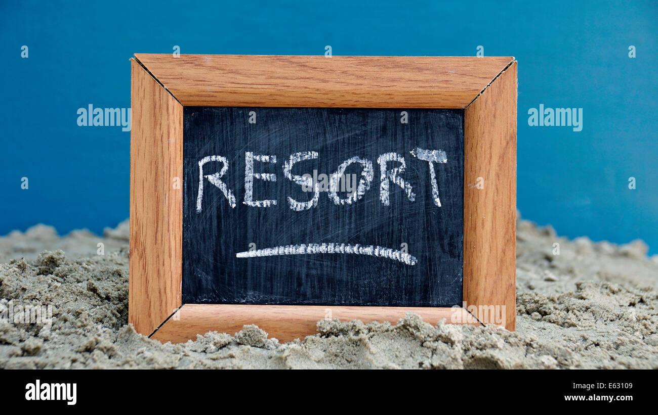 Resort written on a chalkboard at the beach Stock Photo - Alamy
