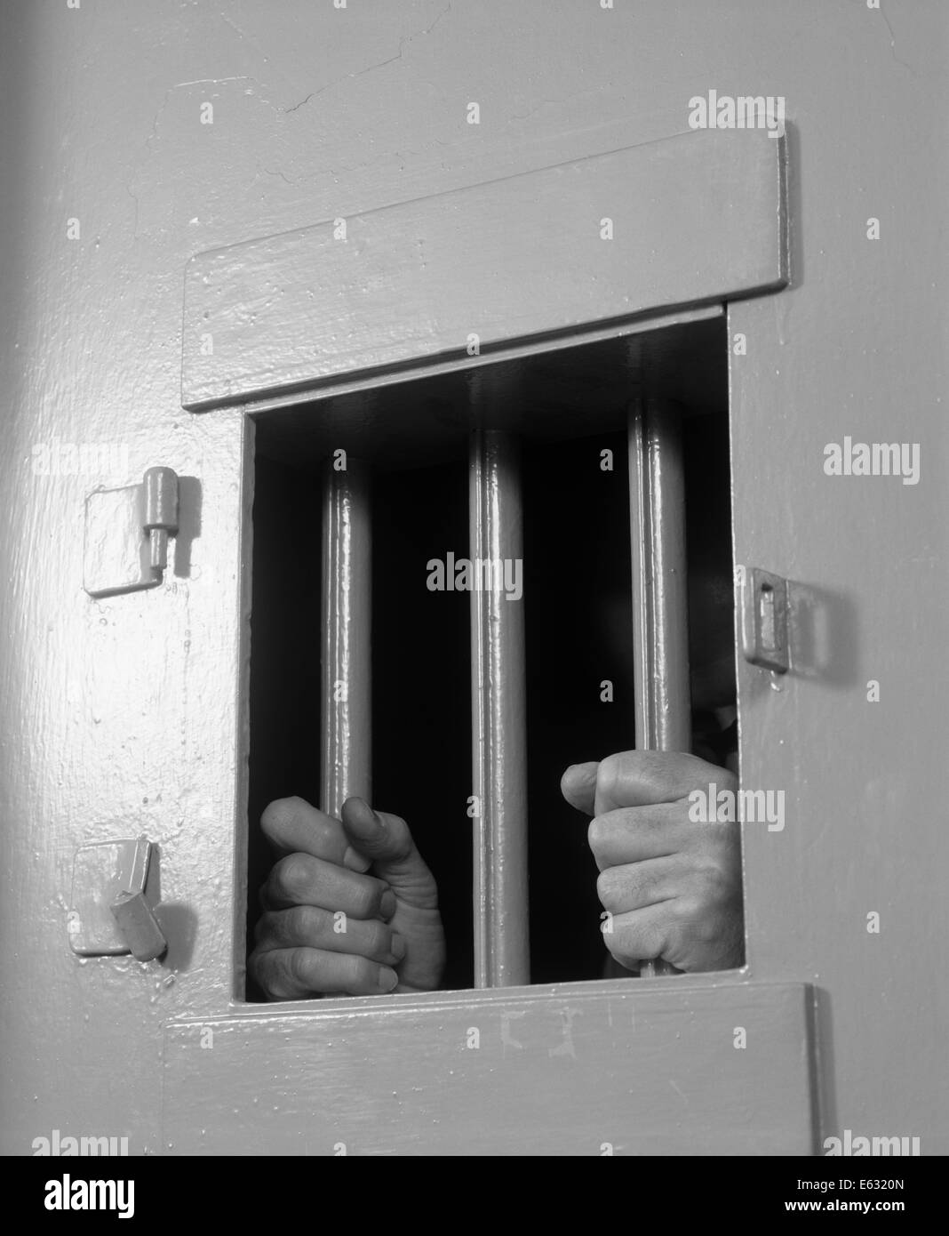 1980s INCARCERATED MAN PRISONER HANDS GRIPPING IRON BARS ON PRISON JAIL ...