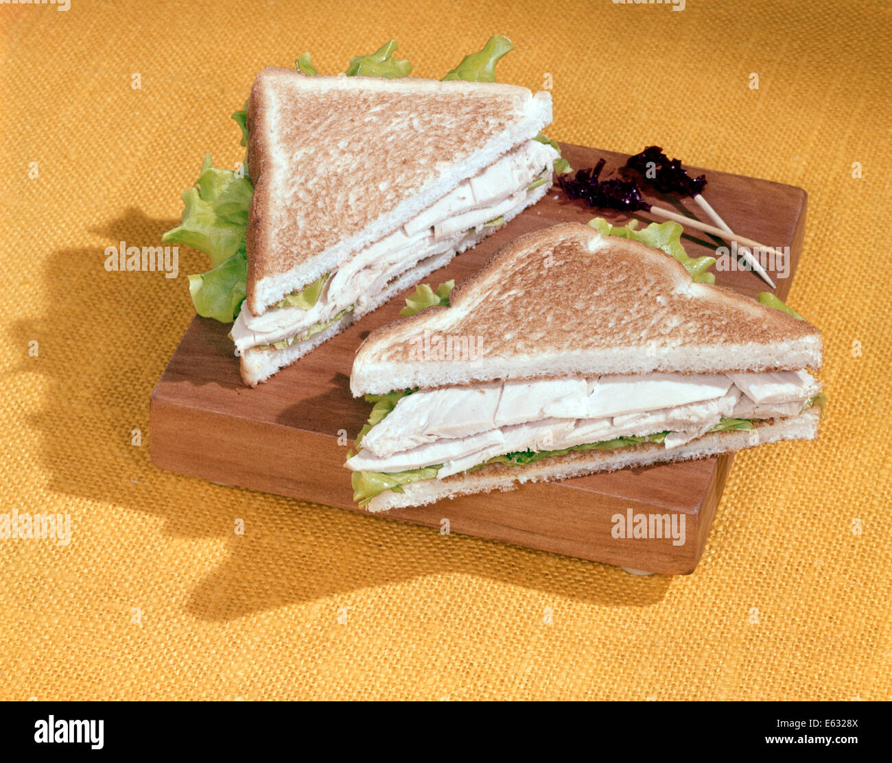 1960s TURKEY SANDWICH LETTUCE TOAST ON CUTTING BOARD Stock Photo - Alamy