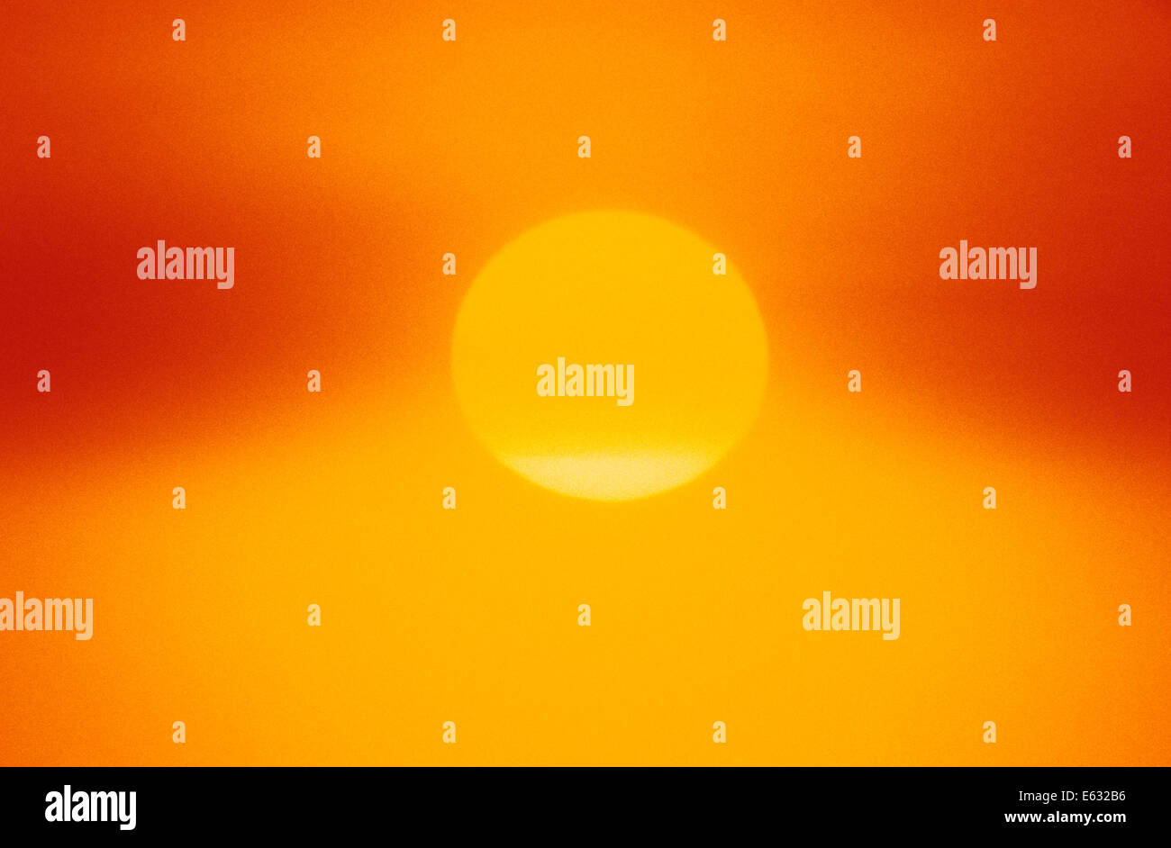 YELLOW BALL OF SUN DROPPING TO HORIZON AT SUNSET Stock Photo - Alamy