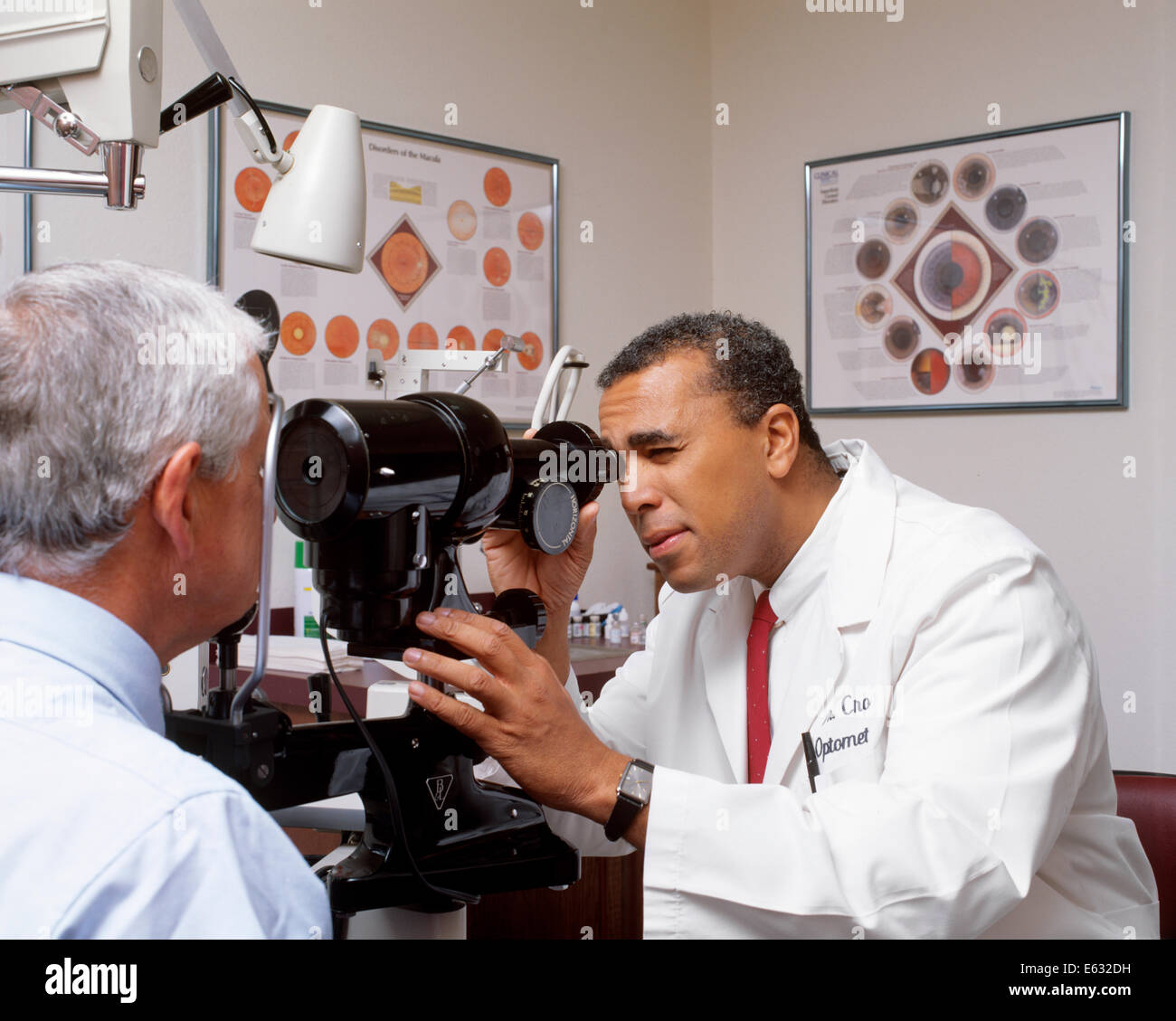 1990s AFRICAN AMERICAN OPTOMETRIST EXAMINING OLDER MAN'S EYES Stock ...