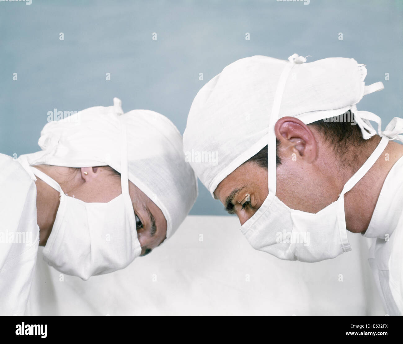 1960s COUPLE MAN WOMAN DOCTOR & NURSE WHITE SURGICAL CAP & MASK HEAD TO ...