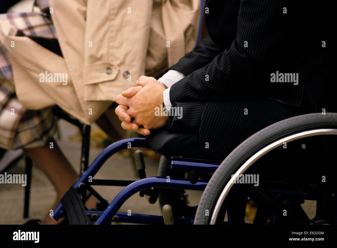 DOUBLE AMPUTEE IN WHEELCHAIR WEARING SIUIT JACKET HANDS CLASPED Stock ...