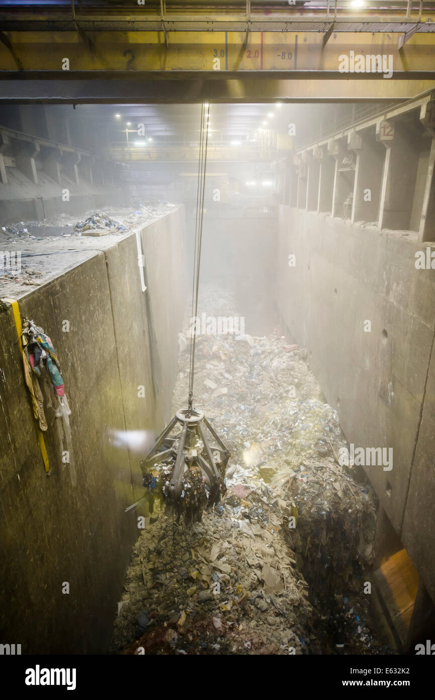 Crane transporting waste to the incinerators at a waste incineration ...
