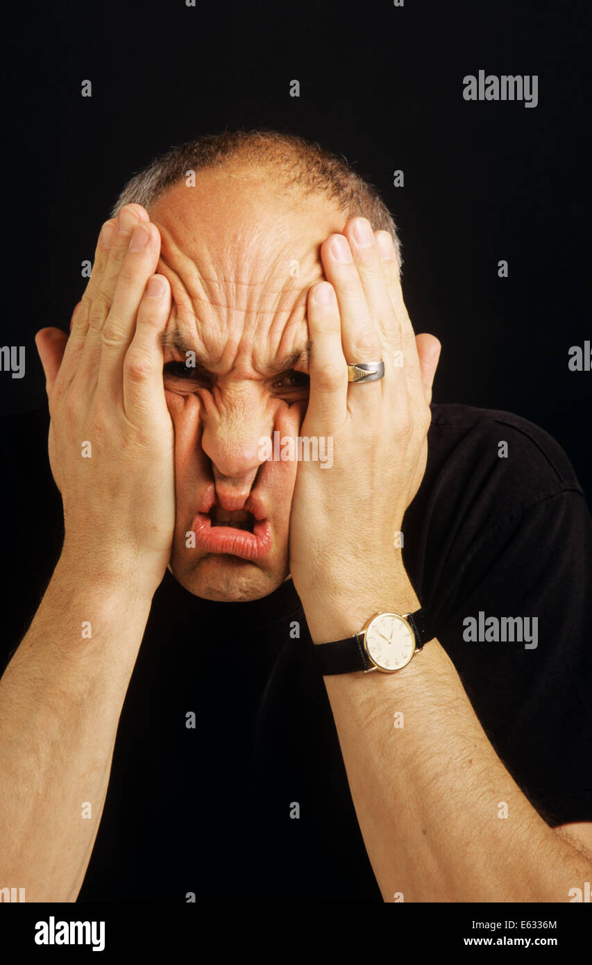 PORTRAIT OF STRESSED MAN SCRUNCHING UP FACE WITH HANDS Stock Photo - Alamy