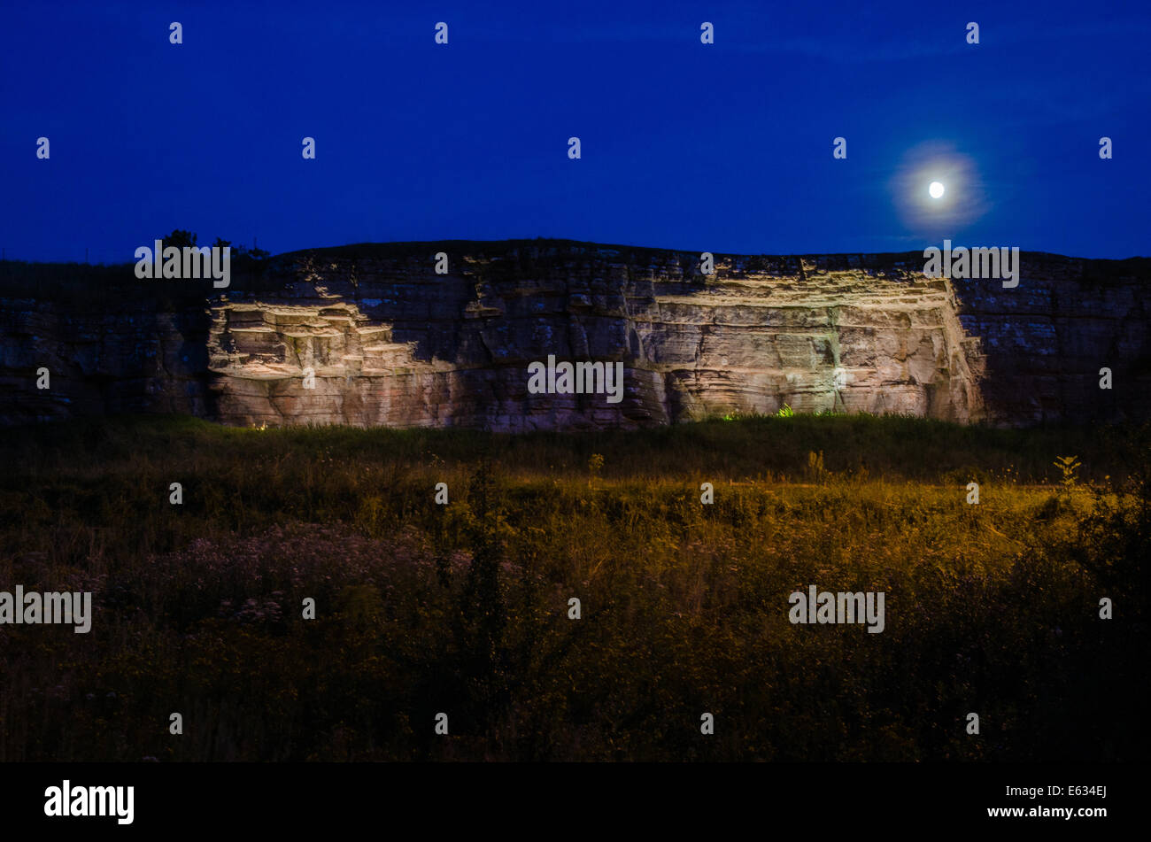 Moonlight over illuminated limestone cliff at the swedish island Oland ...