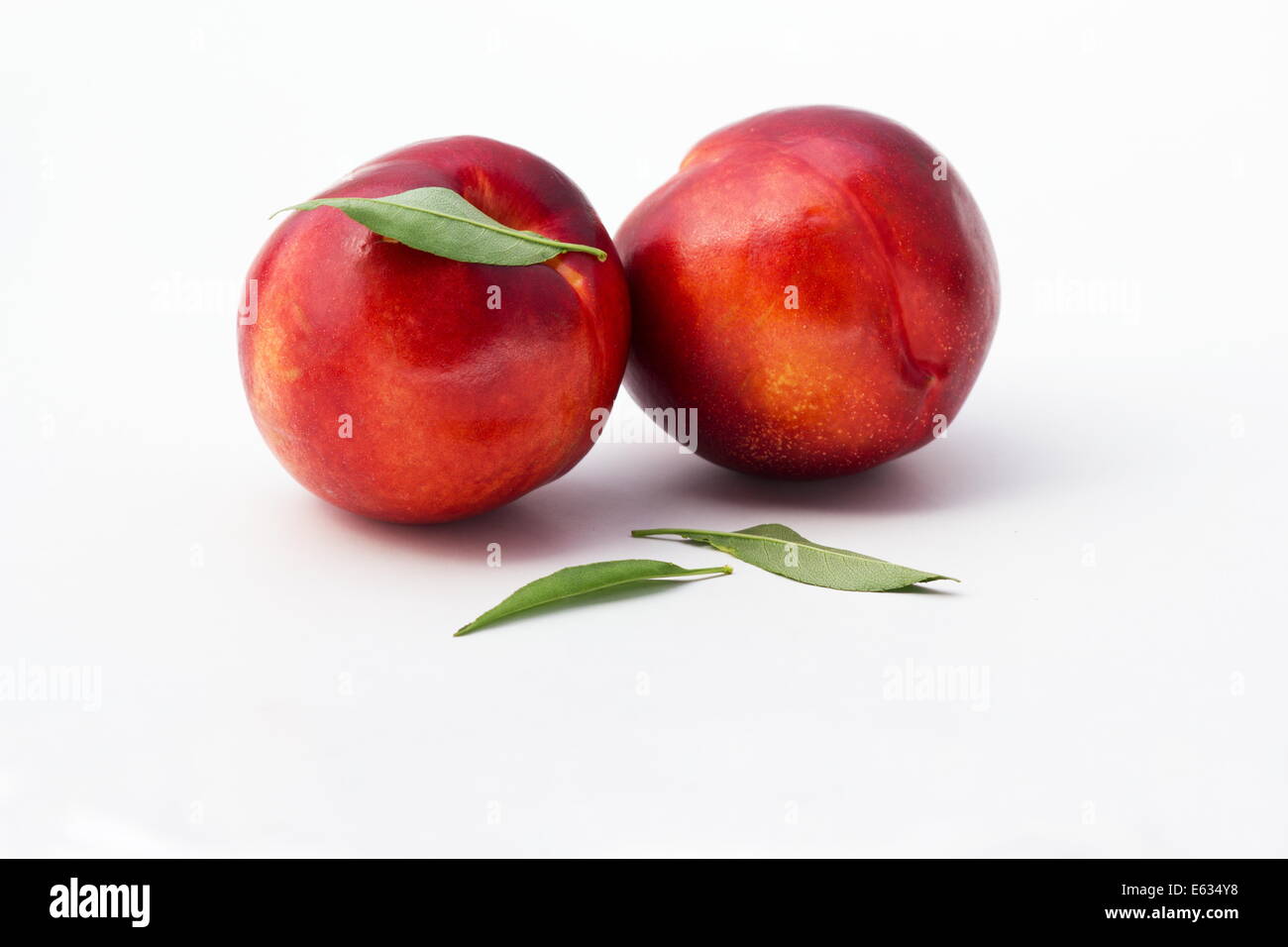 Two nectarines on white background Stock Photo - Alamy