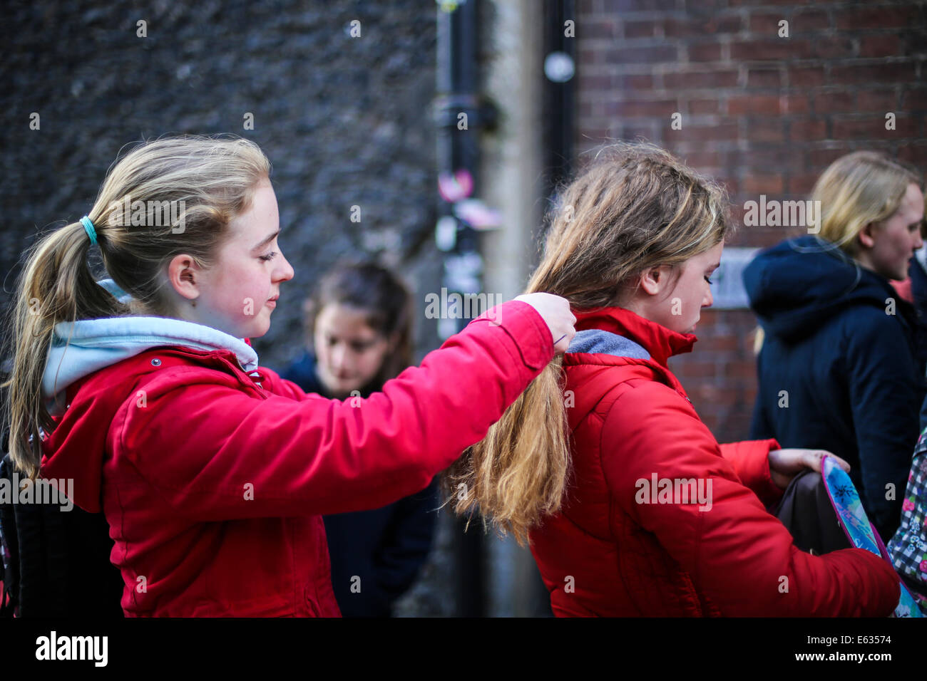 Two young girls one sorting the other ones hair Stock Photo - Alamy