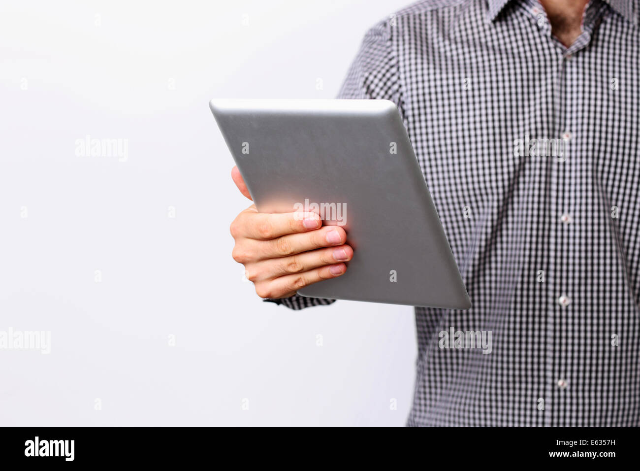 Closeup image of a man holding tablet computer Stock Photo - Alamy
