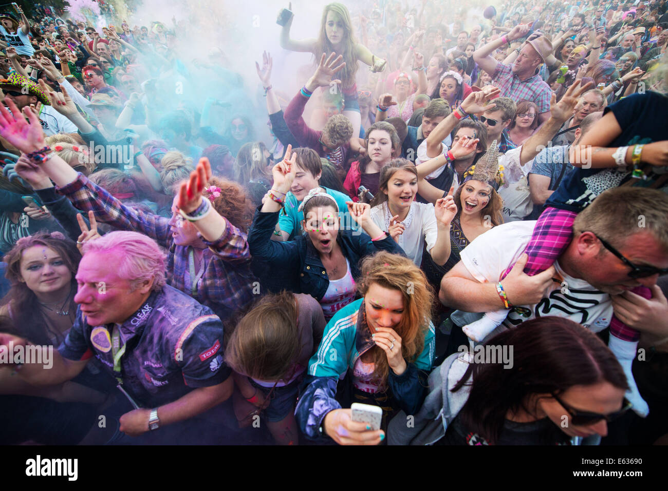 Festival goers throw coloured powder at the Belladrum Tartan Heart ...