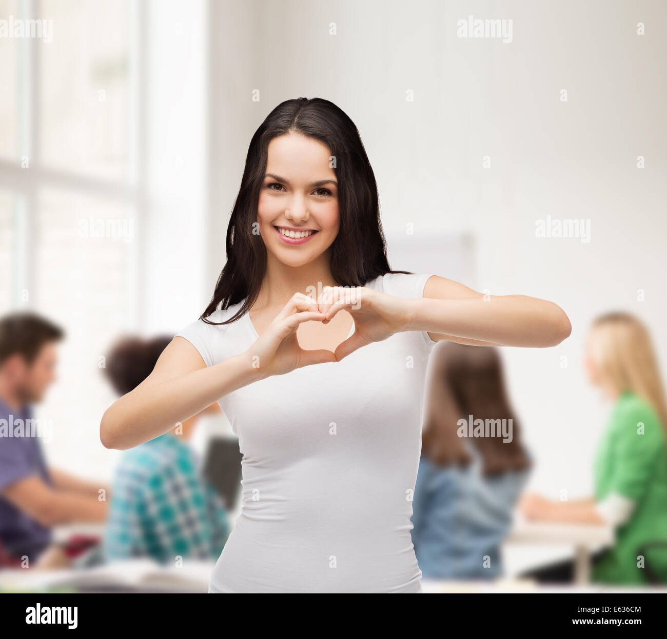 smiling girl showing heart with hands Stock Photo - Alamy