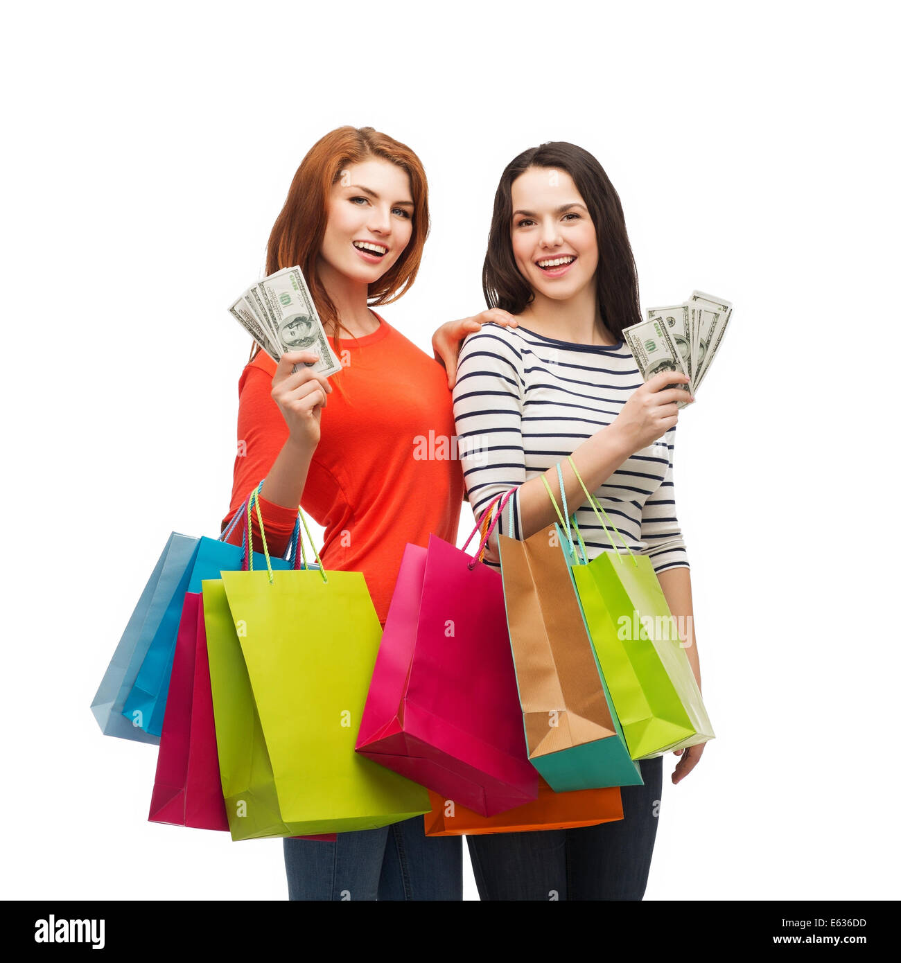 smiling teenage girls with shopping bags and money Stock Photo - Alamy