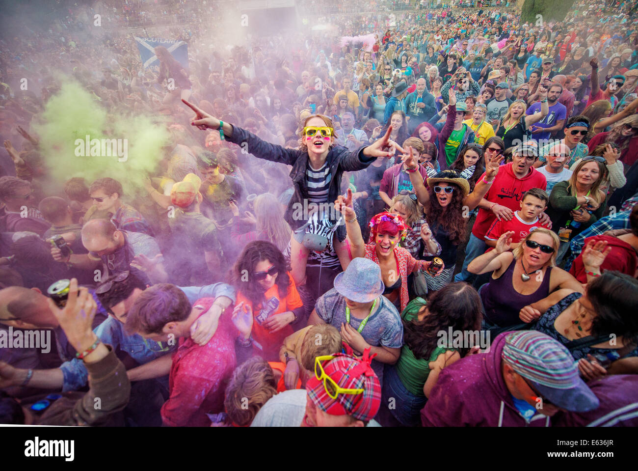 Festival goers throw coloured powder at the Belladrum Tartan Heart ...