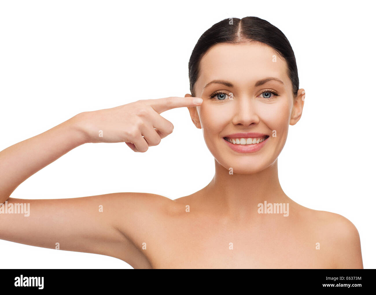 young calm woman pointing to her eye Stock Photo - Alamy
