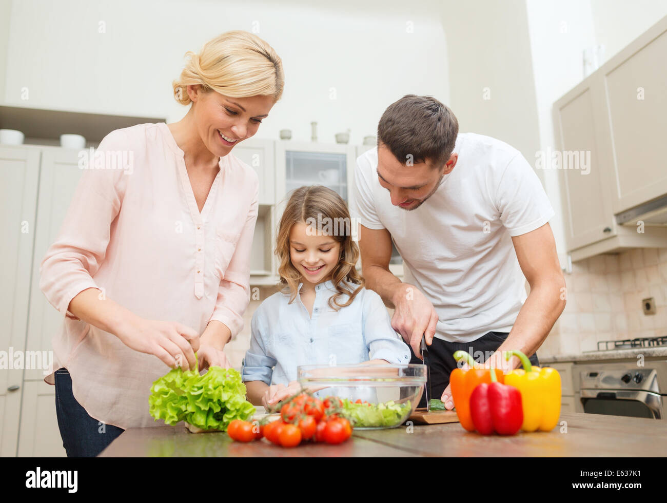 happy family making dinner in kitchen Stock Photo - Alamy