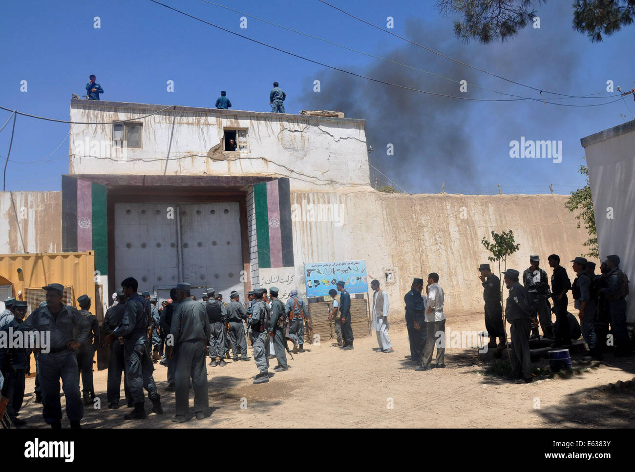 Jauzjan. 13th Aug, 2014. Afghan policemen take position above the ...