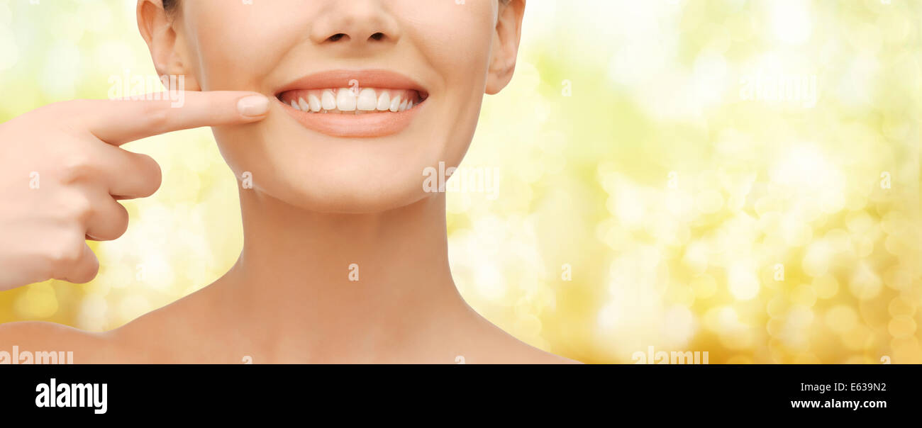 beautiful woman pointing to teeth Stock Photo - Alamy