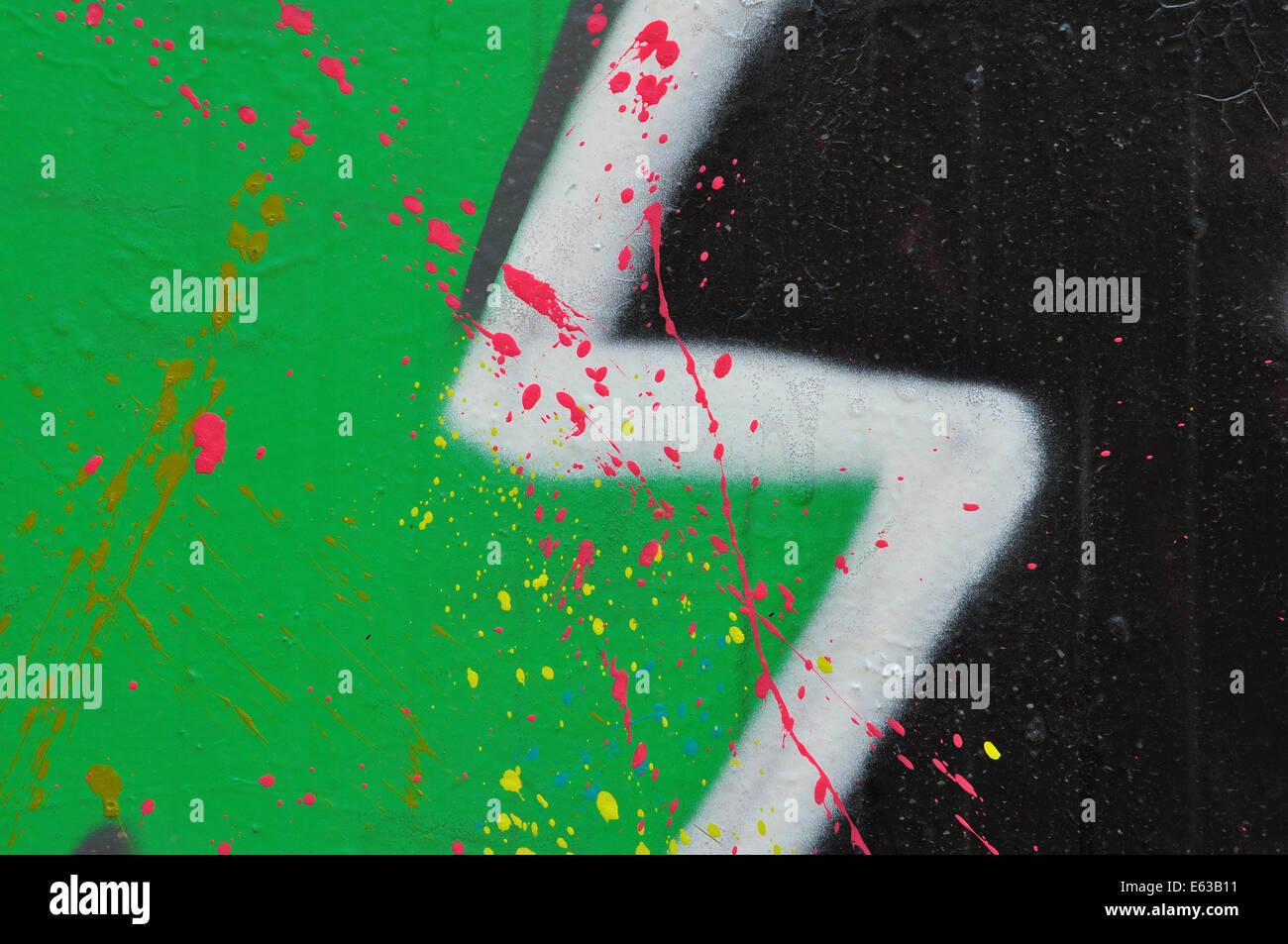 Colorful paint splashed over abstract graffiti background texture Stock ...