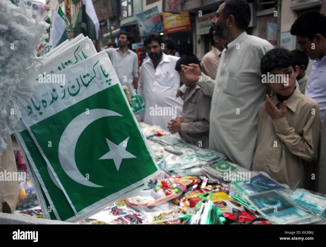 Peshawar, Pakistan. 13th Aug, 2014. Pakistani people shop at a stall on ...