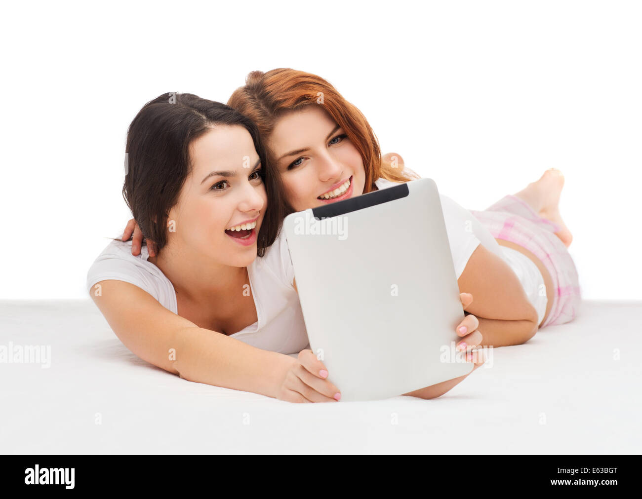 two smiling teenage girls with tablet computer Stock Photo - Alamy