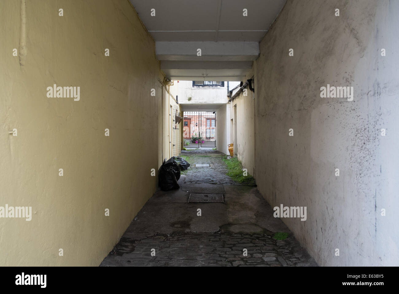 alleyway with gate at the end Stock Photo - Alamy