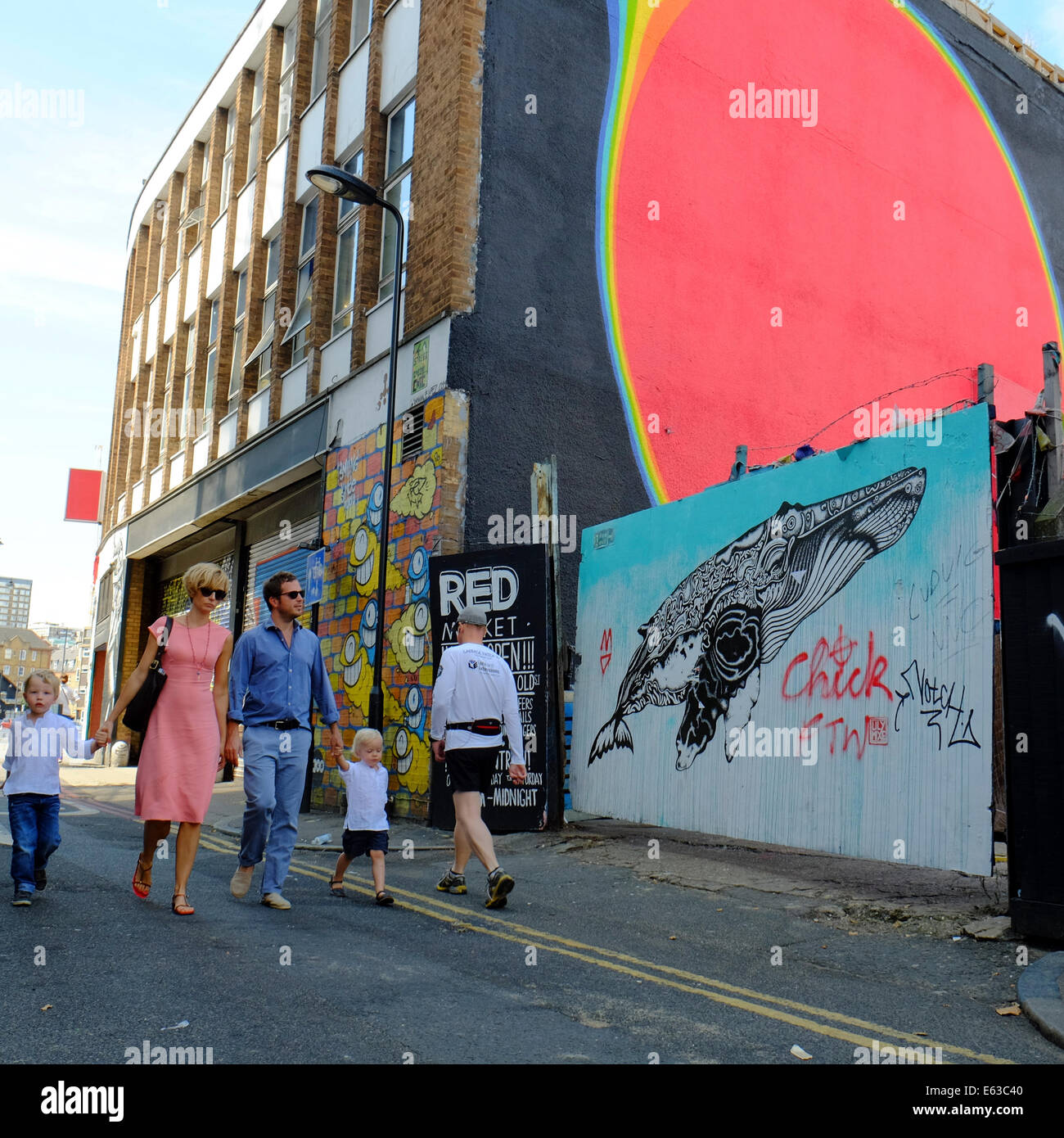 family walking past graffiti wall art in Hackney, London Stock Photo ...