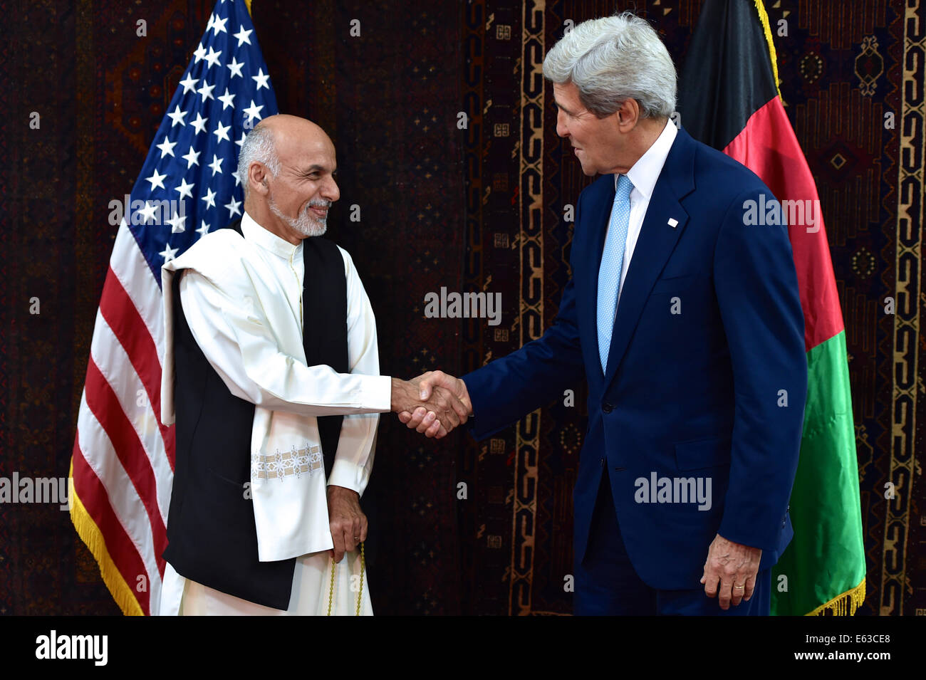 U.S. Secretary of State John Kerry shakes hands with Afghan ...