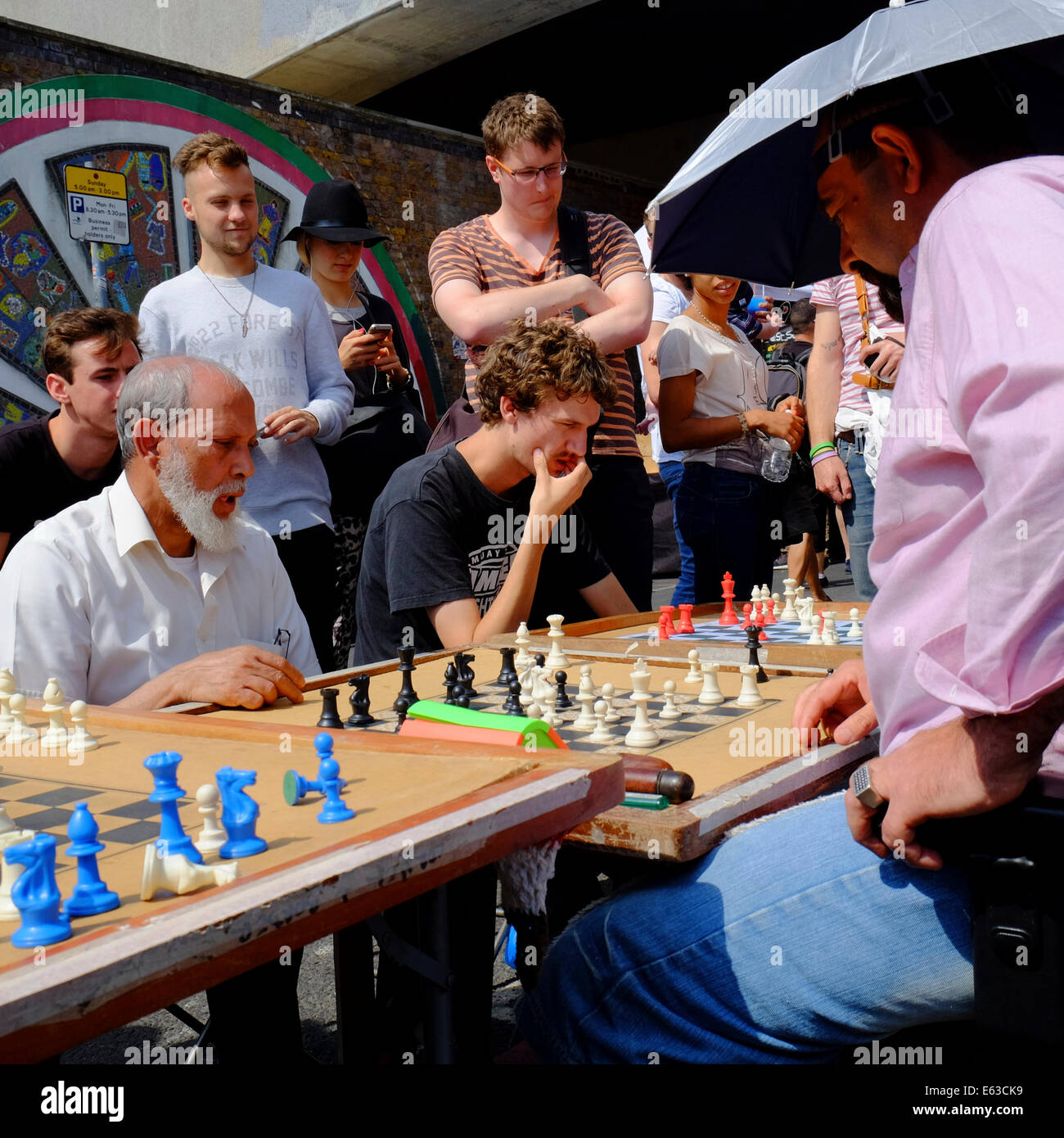 man playing chess against several opponents at the same time in Brick ...