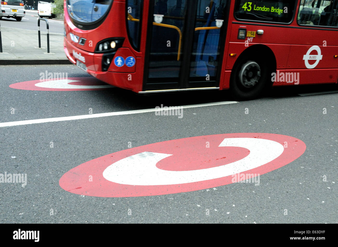 Bus passing Congestion Charge sign printed on road, Old Street ...