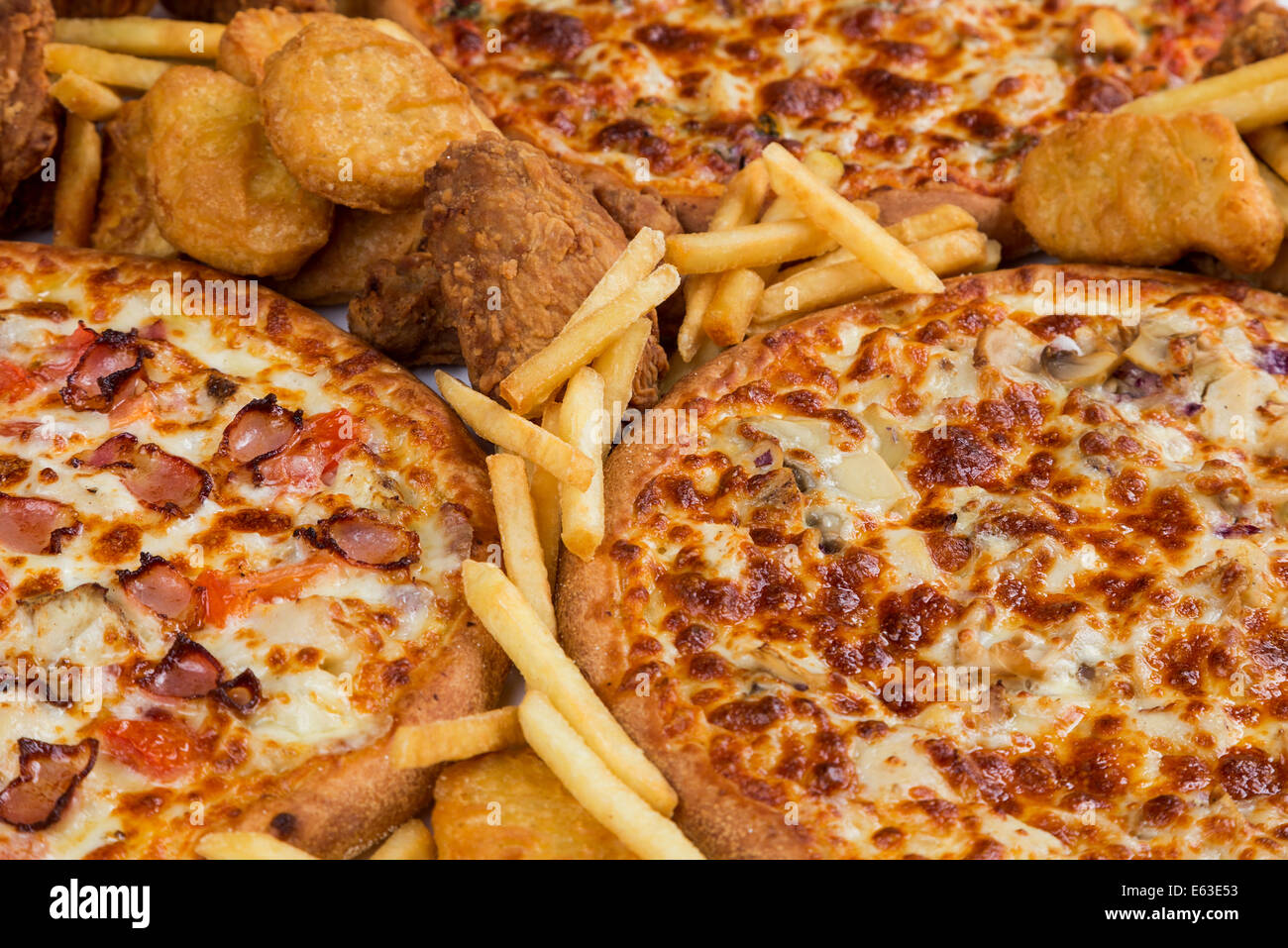 group of fastfood - chicken nuggets, legs, pizzas and fry potatos Stock ...