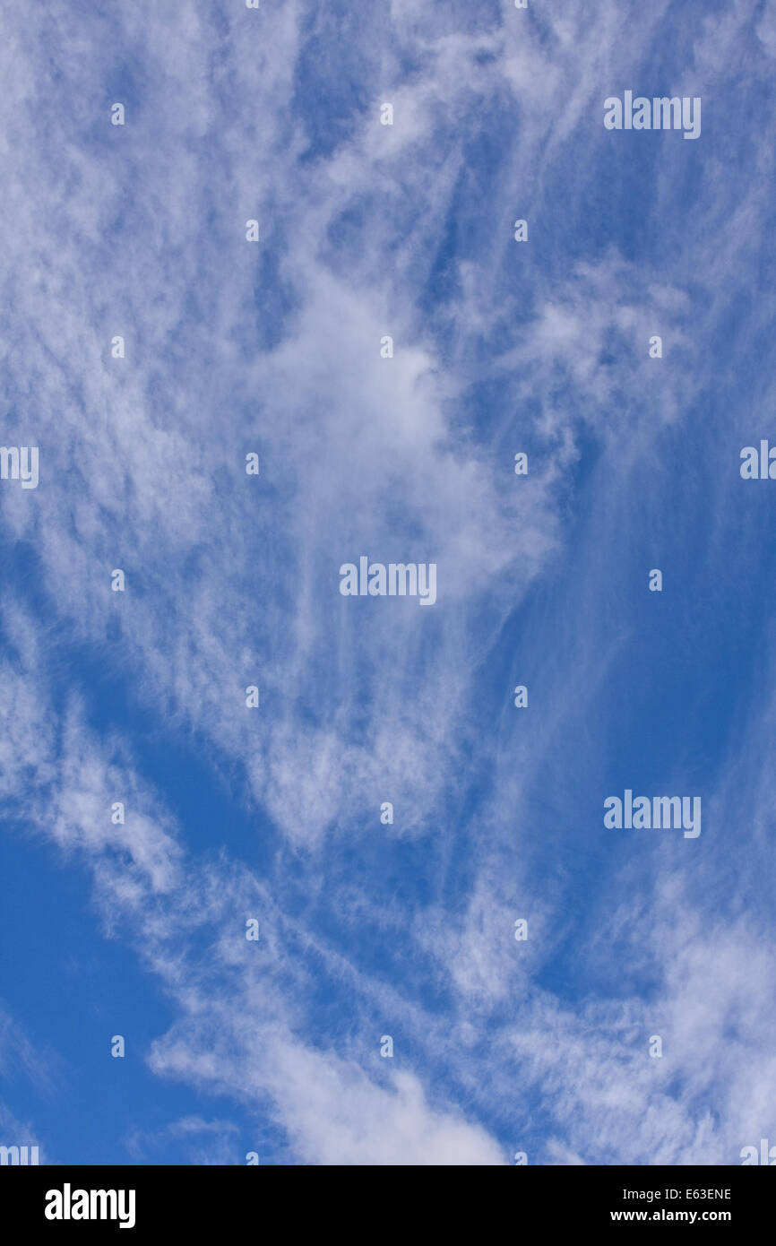 Portrait view of Cirrus cloud formation across the summer skies over ...