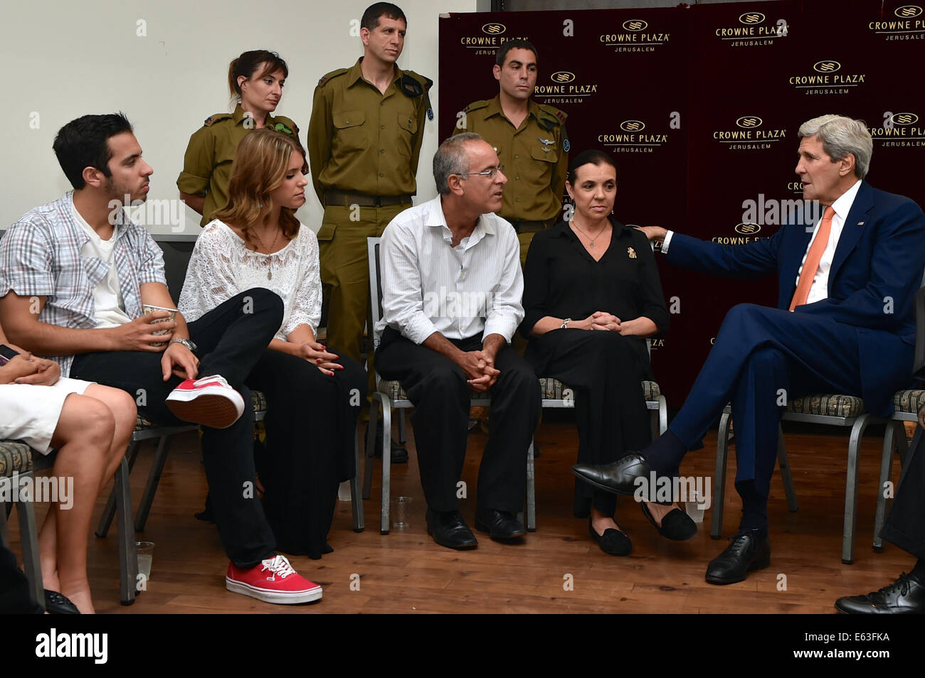 U.S. Secretary of State John Kerry sits with the Steinberg family of ...