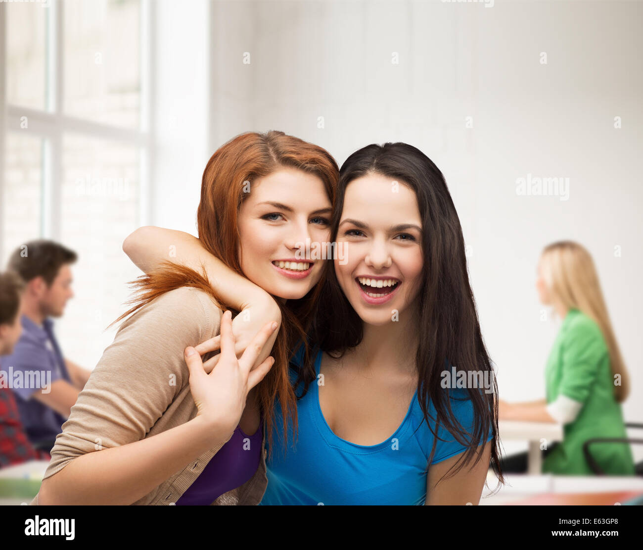 two laughing girls hugging Stock Photo - Alamy