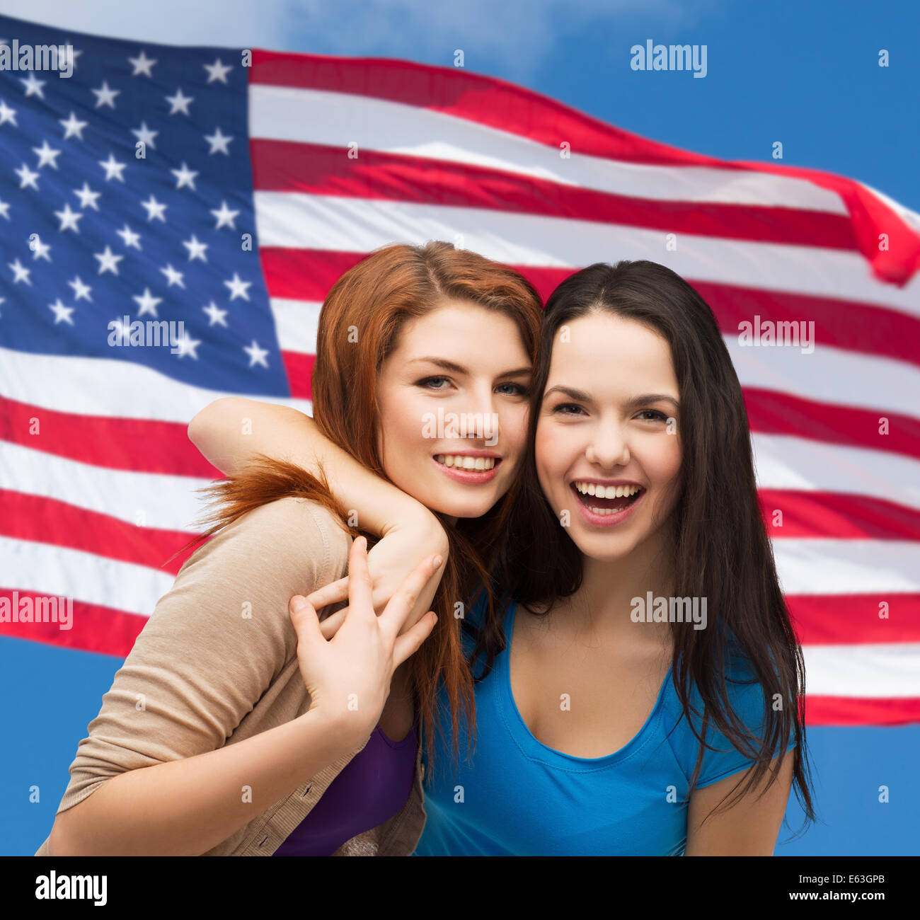two laughing girls hugging Stock Photo - Alamy