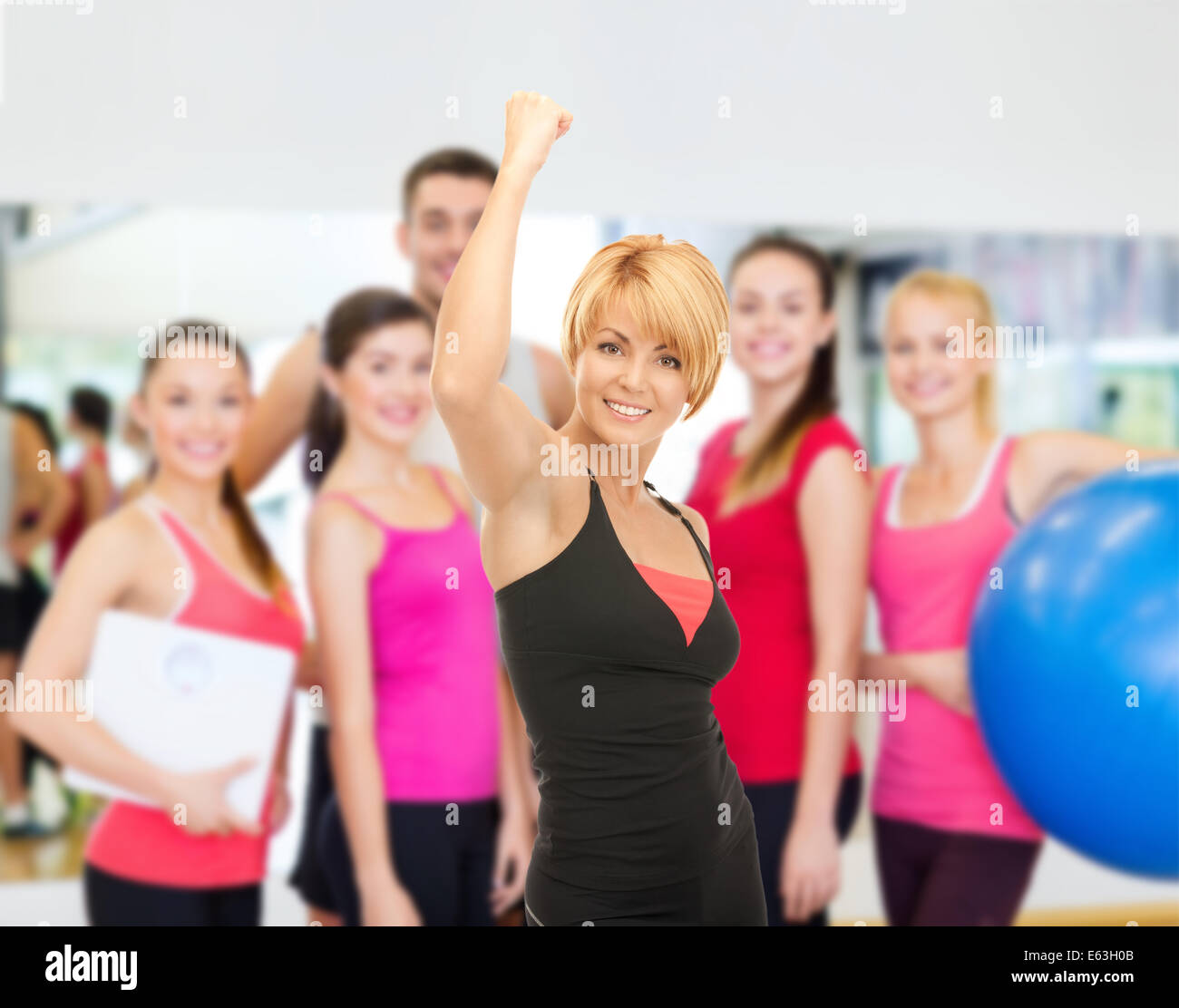 female trainer with expression of triumph Stock Photo - Alamy