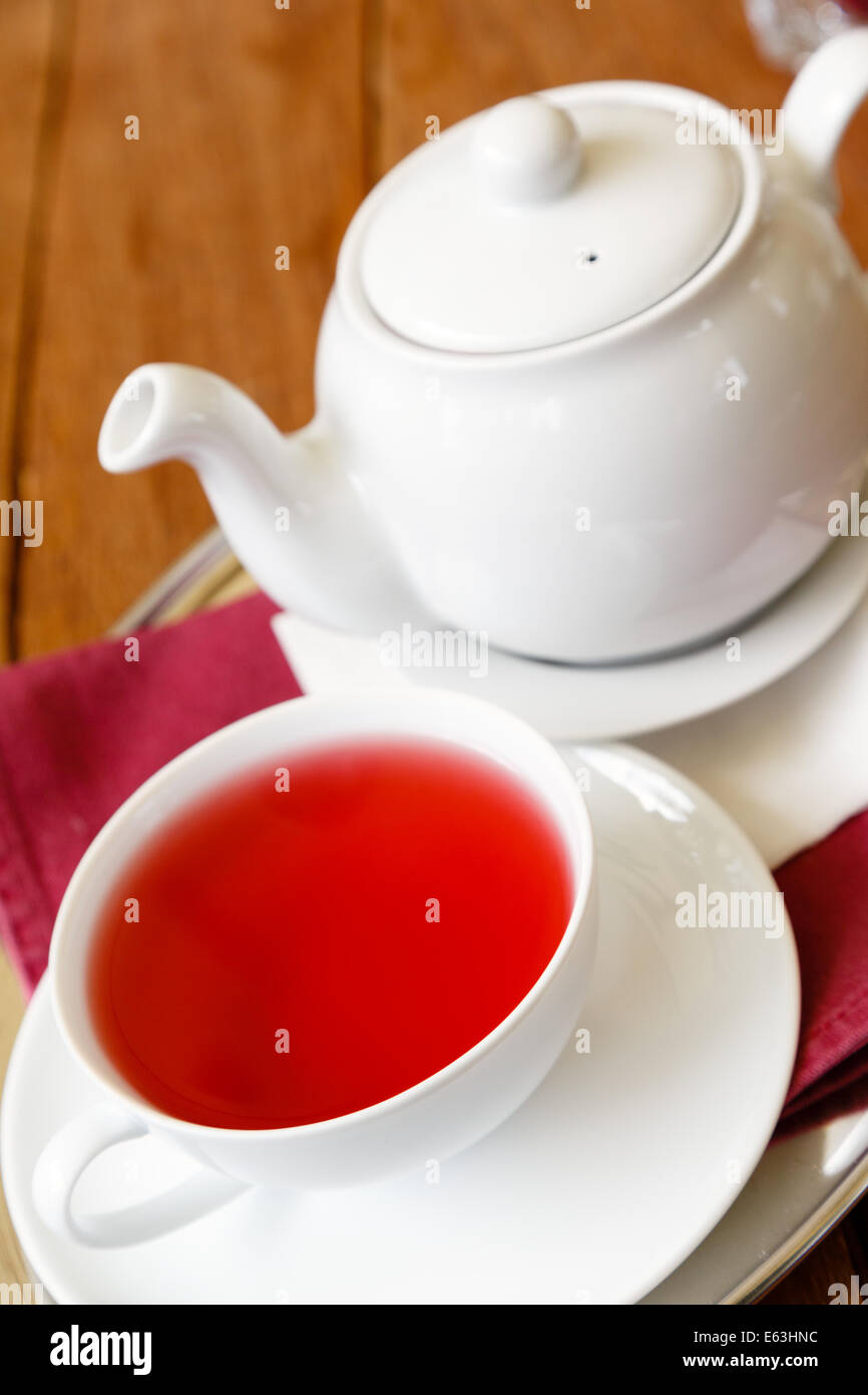 Raspberry tea in cup with teapot Stock Photo - Alamy