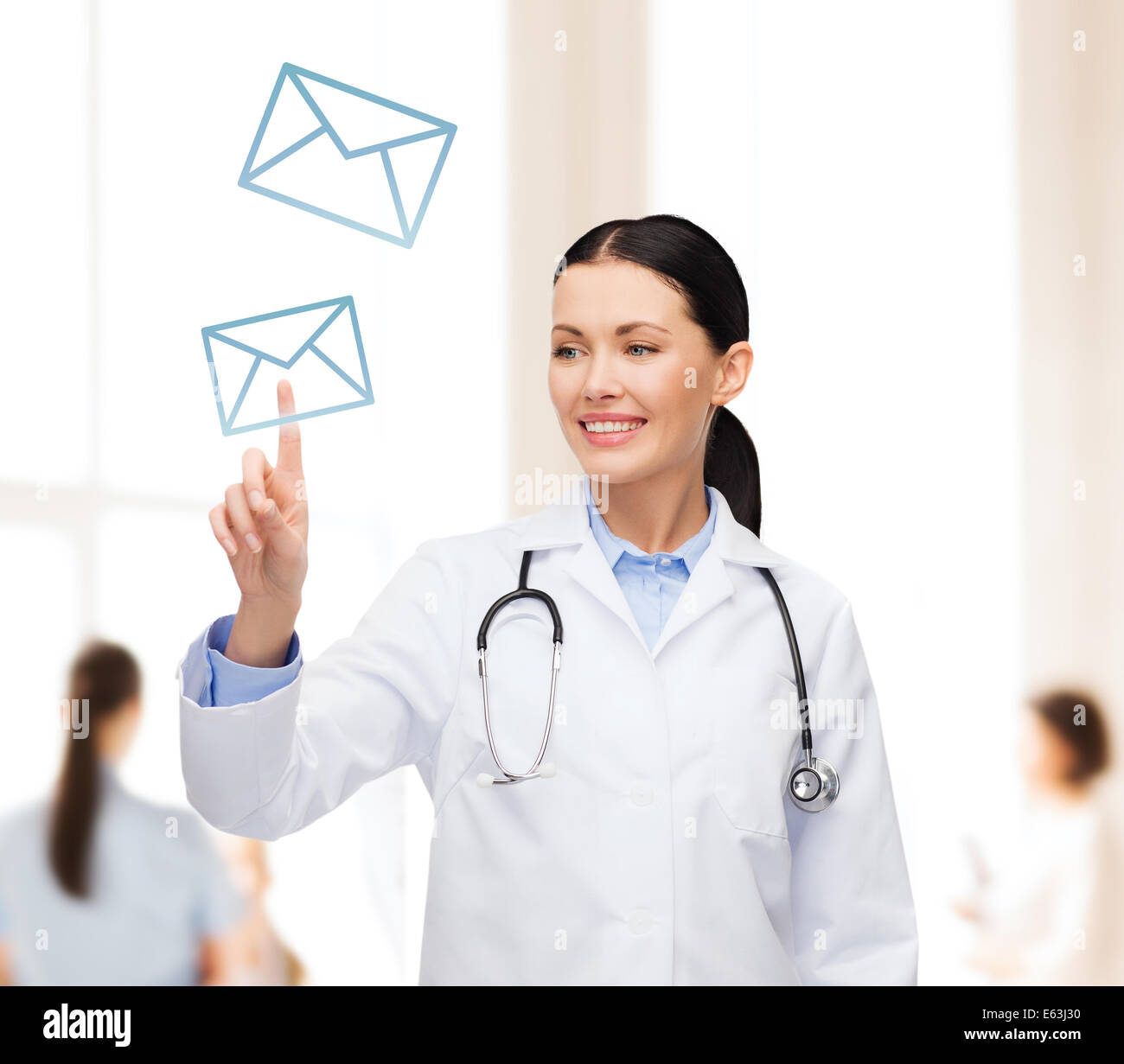 smiling female doctor pointing to envelope Stock Photo - Alamy