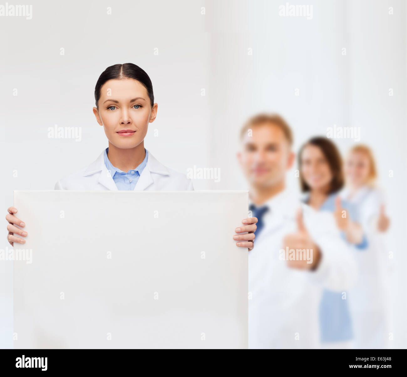 calm female doctor with white blank board Stock Photo - Alamy