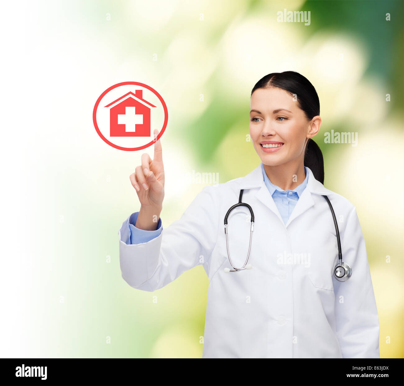 smiling female doctor pointing to hospital sign Stock Photo - Alamy